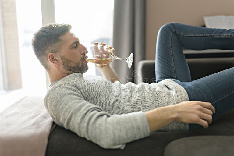 Man Drinking Wine while Having Fun Lay on Sofa Stock Photo - Image of ...