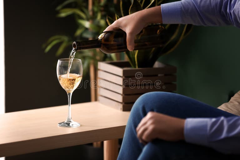 Man drinking wine at home stock photo. Image of booze - 151348834