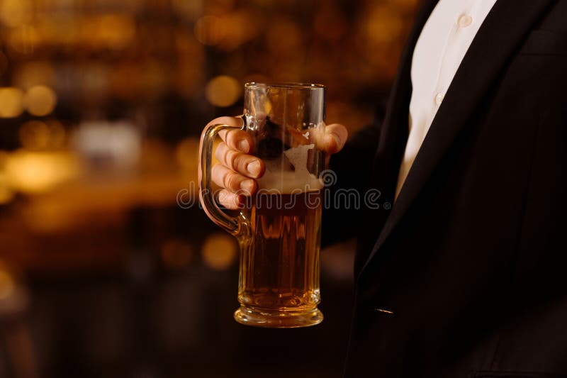 A Man Drinks Beer. Side View of Handsome Bald Man Drinking Beer in ...