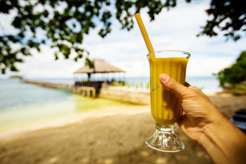 Man Drinks Mango Juice on the Beach Stock Photo - Image of drink, mango ...