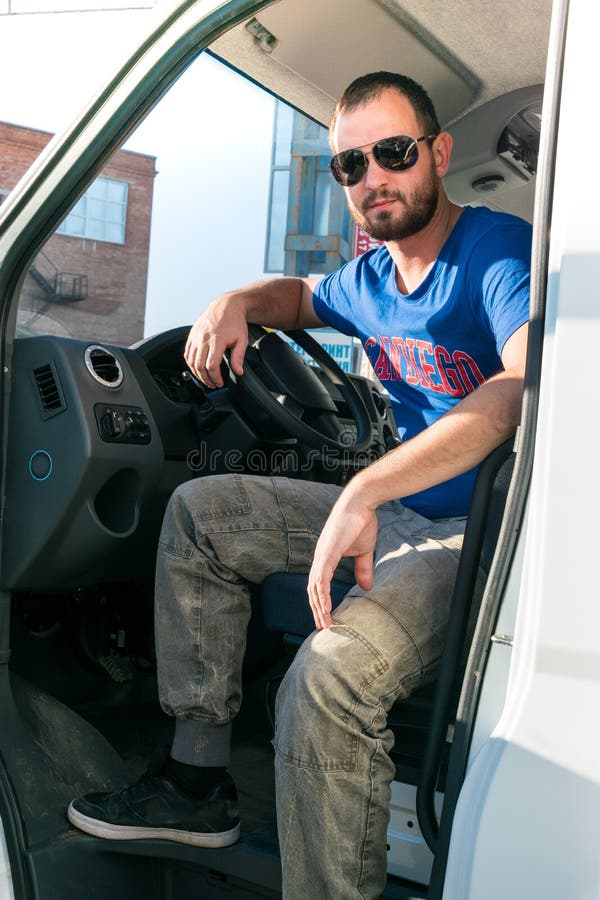A Man Driver is Sitting in the Cab of a Modern Truck. Stock Image ...
