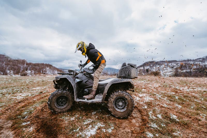 A Man Drives an ATV in the Mud. Drift Driving an ATV Quad in Mud and ...