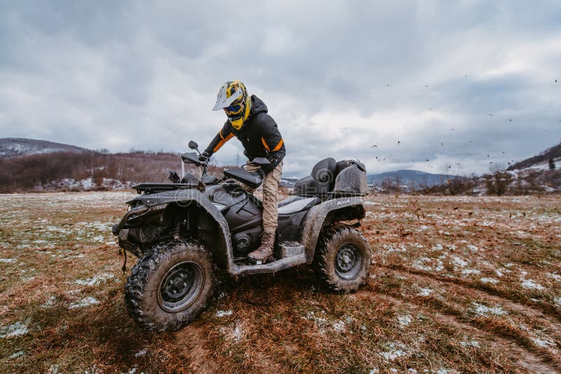 A Man Drives an ATV in the Mud. Drift Driving an ATV Quad in Mud and ...