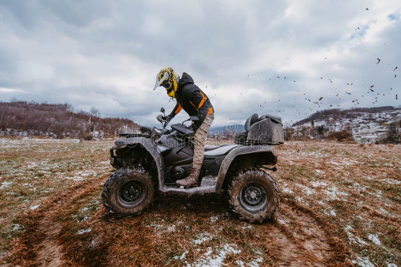 A Man Drives an ATV in the Mud. Drift Driving an ATV Quad in Mud and ...