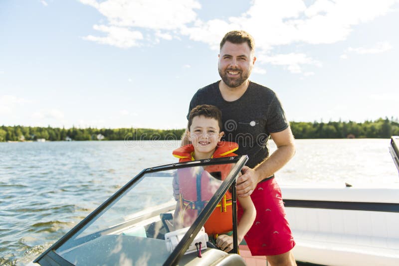 Man Driving Boat on Holiday with His Son Kid Stock Image - Image of ...