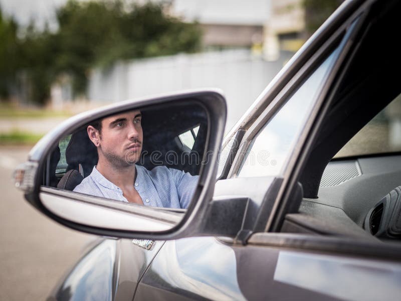 Man Driving a Car while Looking in the Side Mirror Stock Image - Image ...