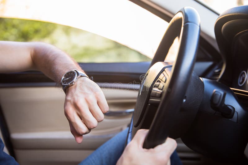 Man Driving a Car and Looking at Watch Stock Image - Image of clock ...