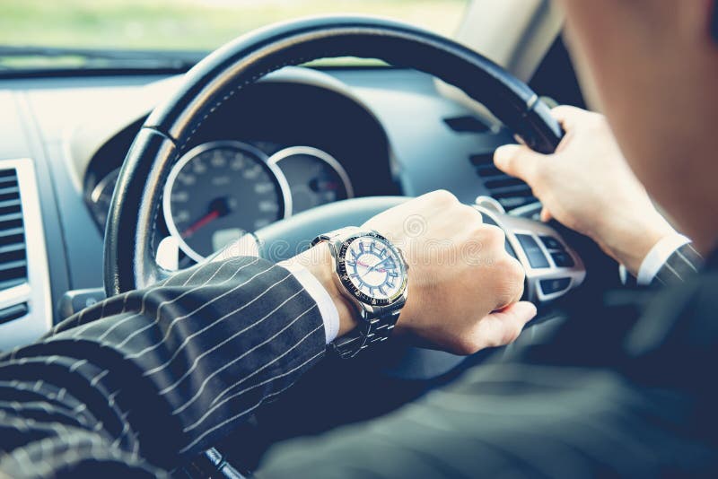Man Driving a Car and Looking at Watch Stock Photo - Image of leasing ...