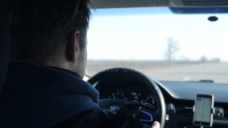 Man Driving Car Driving on Road Using Road Map App on Phone. Slow ...