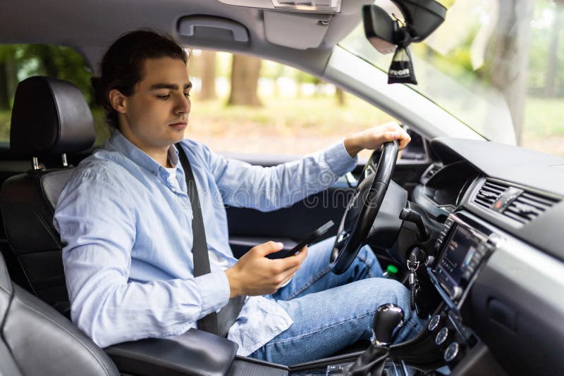 Young Man Driving Car and Texting on the Cellphone Stock Photo - Image ...