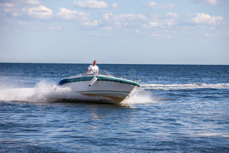 Man driving a fast boat stock photo. Image of drive, outboard - 37524830
