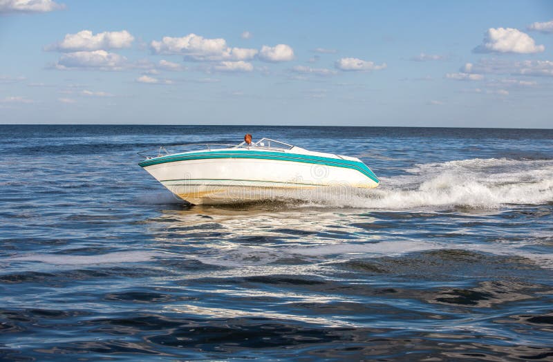 Man driving a fast boat stock photo. Image of leisure - 37524952
