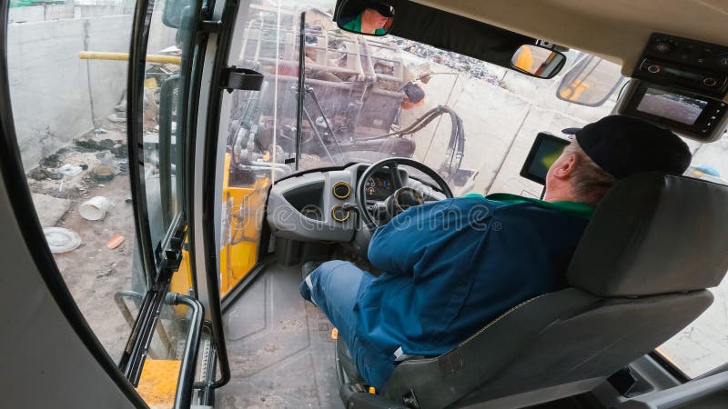 Man Driving a Front Loader Forward and Backward, Inside the Cabin View ...