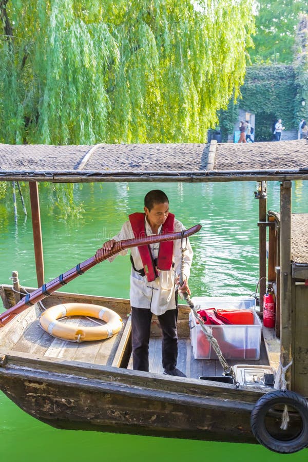 Man Driving a Paddle Boat through the River in Wuzhen Editorial Photo ...