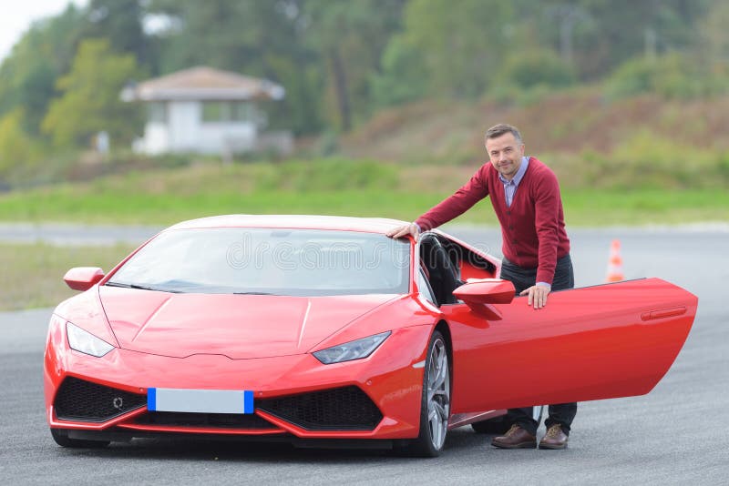 Man driving red car stock photo. Image of cdplayer, ashtray - 197679230