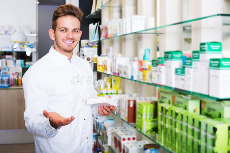 Man druggist in pharmacy stock photo. Image of cheerful - 81197136