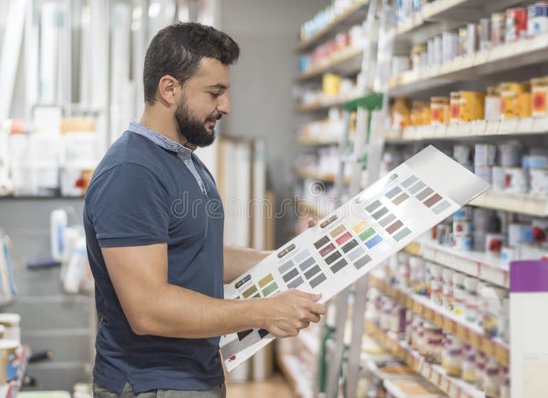 Man in Drugstore Selecting Paint Color for His Work Stock Photo - Image ...