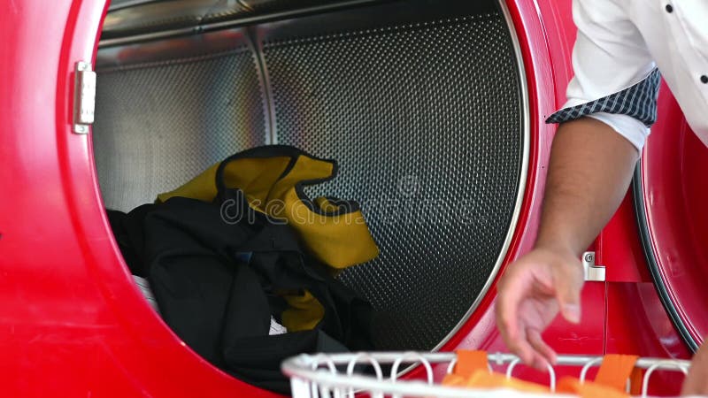 Drying Clothes - Putting Clothes into a Drying Machine in the ...