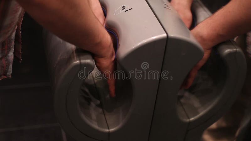 Man Drying Hands with Air Drier in Public Toilet Stock Video - Video of ...
