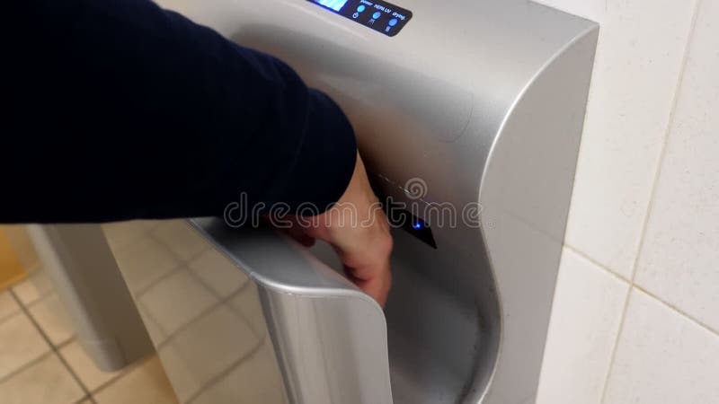 Man Drying Hands Using Dryer in the Restroom Stock Video - Video of ...