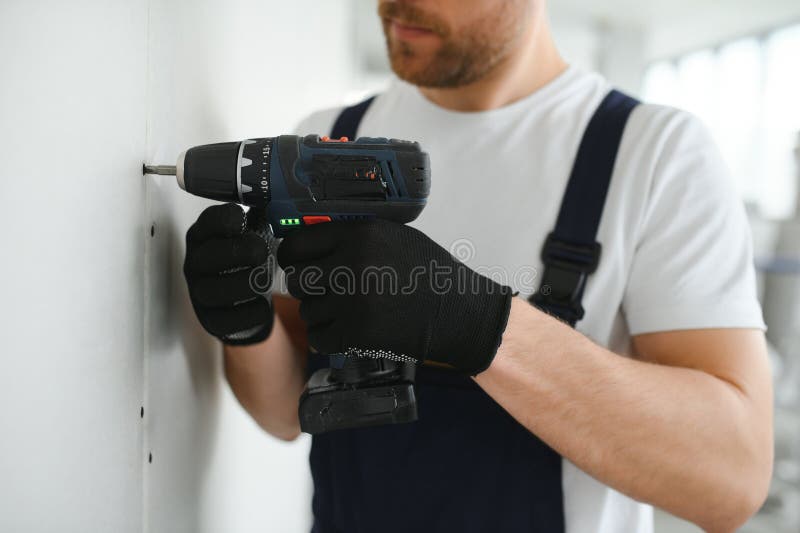 Man Drywall Worker Installing Plasterboard Sheet To Wall. Stock Image ...