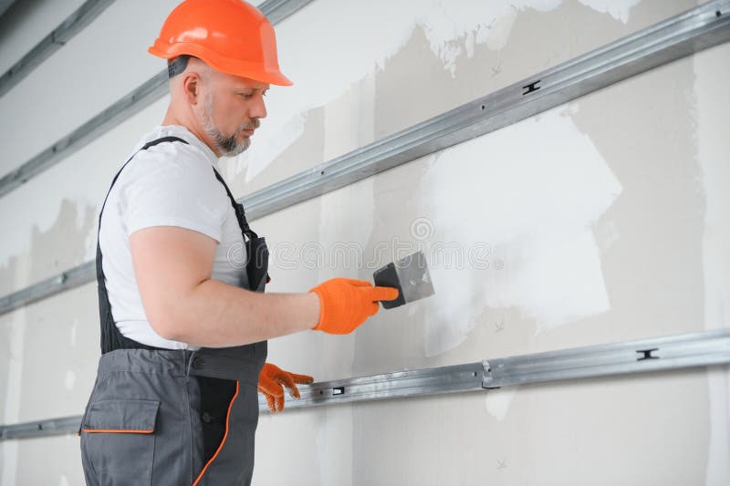 Man Drywall Worker or Plasterer Putting Mesh Tape for Plasterboard on a ...