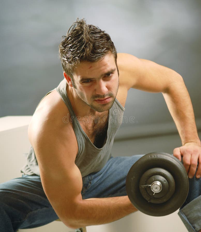 A man with a dumb-bell stock image. Image of shape, fitness - 3368071