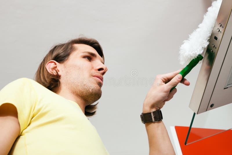 Man dusting his apartment stock image. Image of clean - 12399833