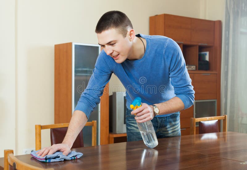 Man Dusting Wooden Table with Rag and Cleanser at Home Stock Photo ...