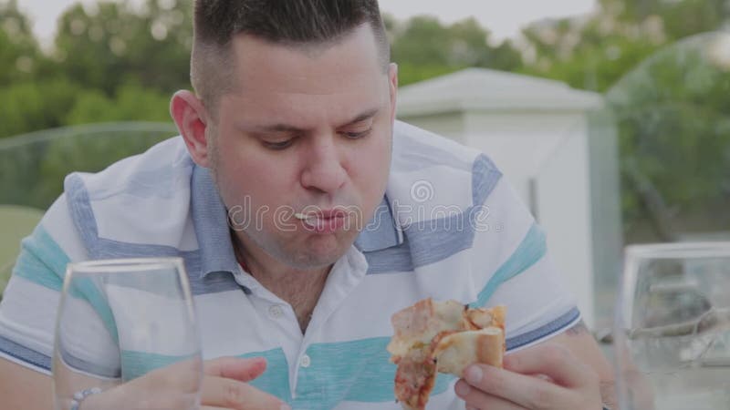 A Man Eagerly Eats Junk Food in a Restaurant. Stock Footage - Video of ...