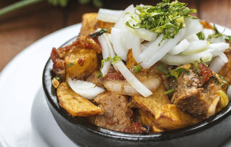 Man Eating Beef Stew with Potatoes, Carrots and Herbs on Black ...