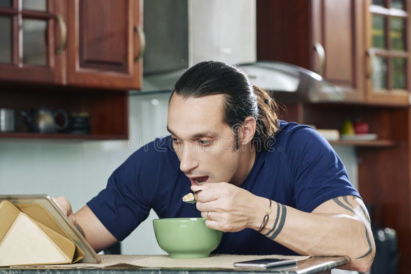 Man eating breakfast stock photo. Image of oats, handsome - 135268362