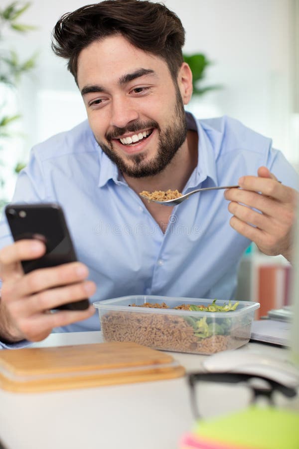 Man Eating Breakfast Whilst Checking Mobile Phone Stock Image - Image ...