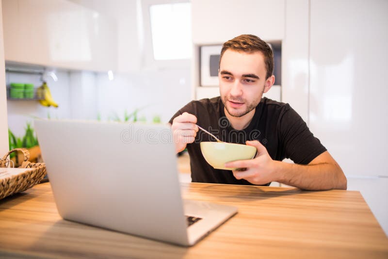 Man Eating Breakfast Whilst Using Laptop Kitchen Stock Photos - Free ...
