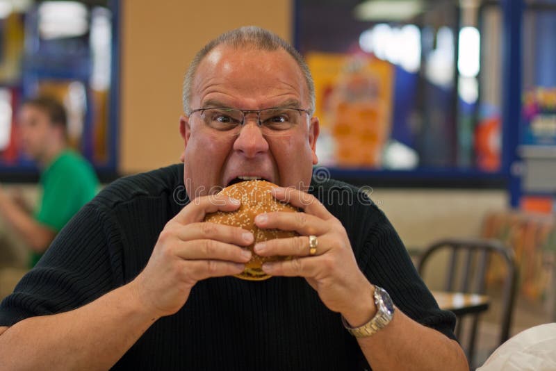 Man Eating Burger in Fast Food Restaurant Stock Image - Image of green ...