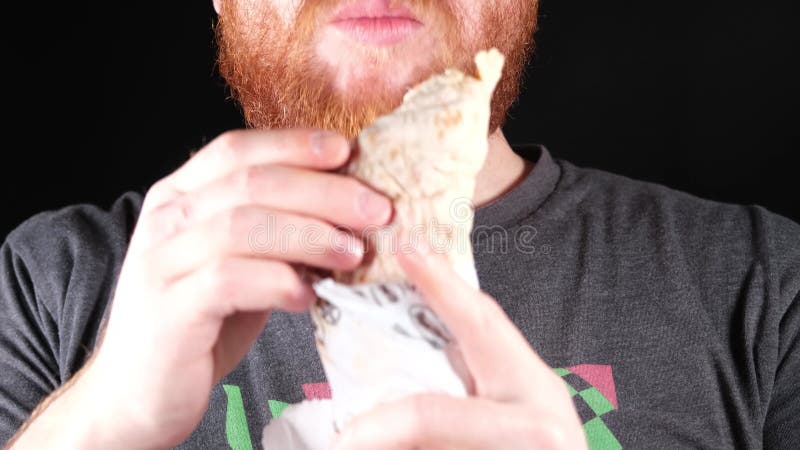 Man eating burrito stock footage. Video of bearded, pita - 299739588