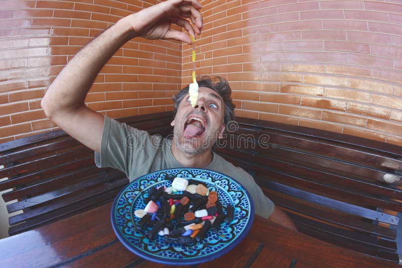 Man eating candies stock image. Image of praline, funny - 33595321