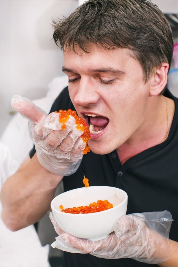 The man is eating caviar stock photo. Image of product - 65462248