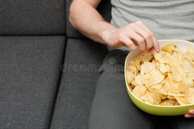 Man eating chips stock photo. Image of drink, male, movie - 10093838