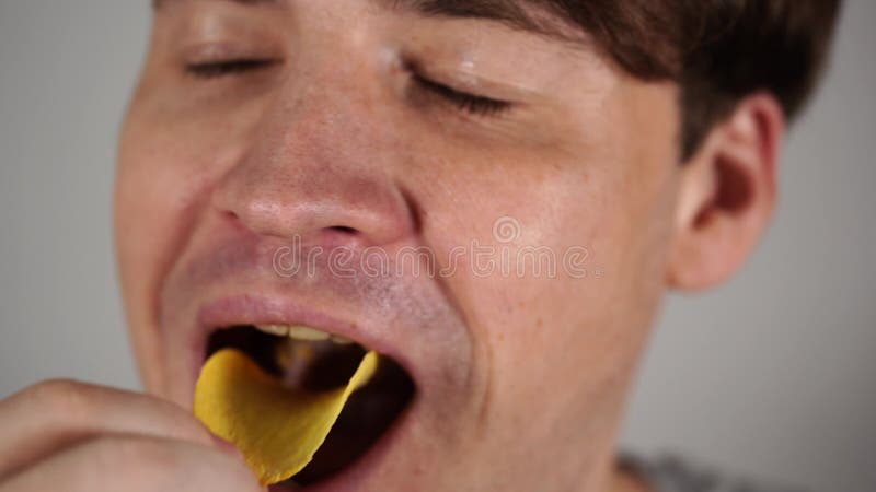 Man Eating Chips Close Up. Cropped View of Man Eating Chips Stock ...