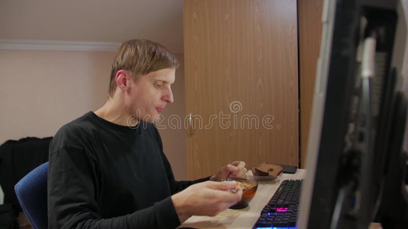 Man Eating at the Computer stock footage. Video of designer - 201779398
