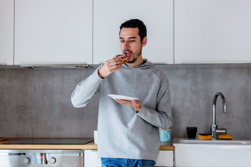 Man Eating Donut on Breakfast at Kitchen Stock Photo - Image of diet ...