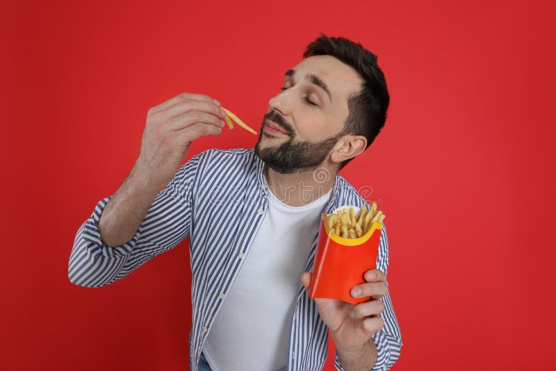 Man Eating French Fries on Red Background Stock Photo - Image of fried ...
