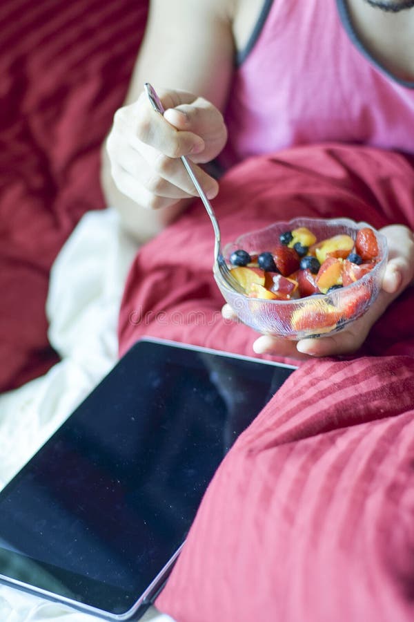 Man Eating Fruit and Using Tablet Computer Stock Image - Image of wake ...