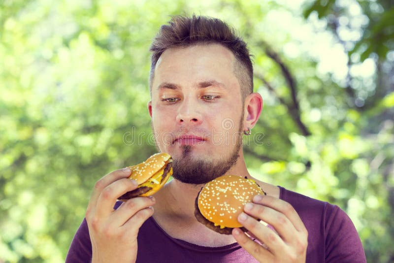 Man eating a hamburger stock image. Image of fast, body - 75022047