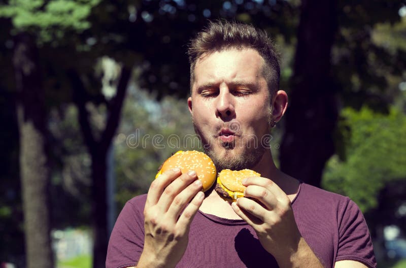 Man eating a hamburger stock photo. Image of lifestyle - 75022116