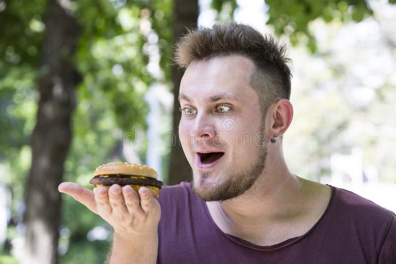 Man eating a hamburger stock photo. Image of hungry, breakfast - 76043302