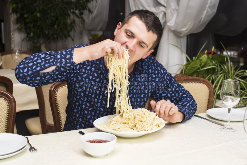Man Eating a Large Portion of Pasta Stock Photo - Image of suit, fine ...