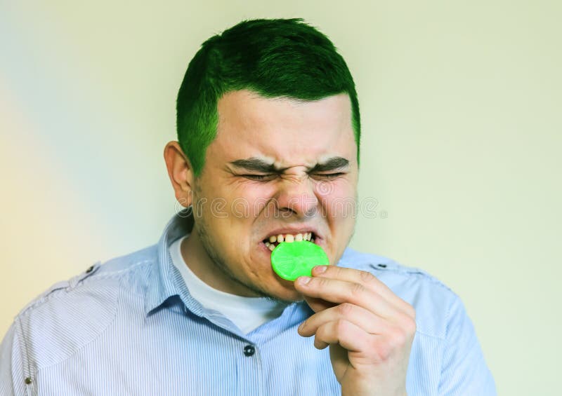 Man Eating Lemon. Wince from Sour Taste Stock Image - Image of food ...