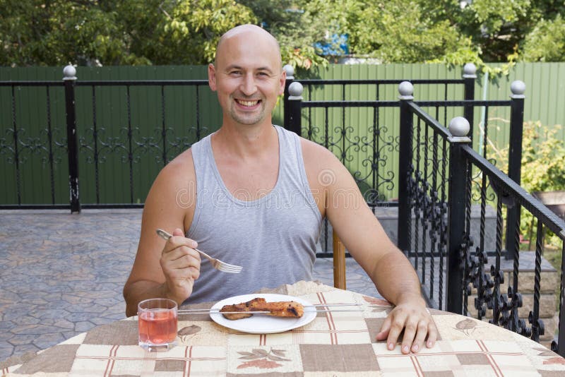 A Man is Eating Meat from a Skewer Stock Image - Image of luxury ...